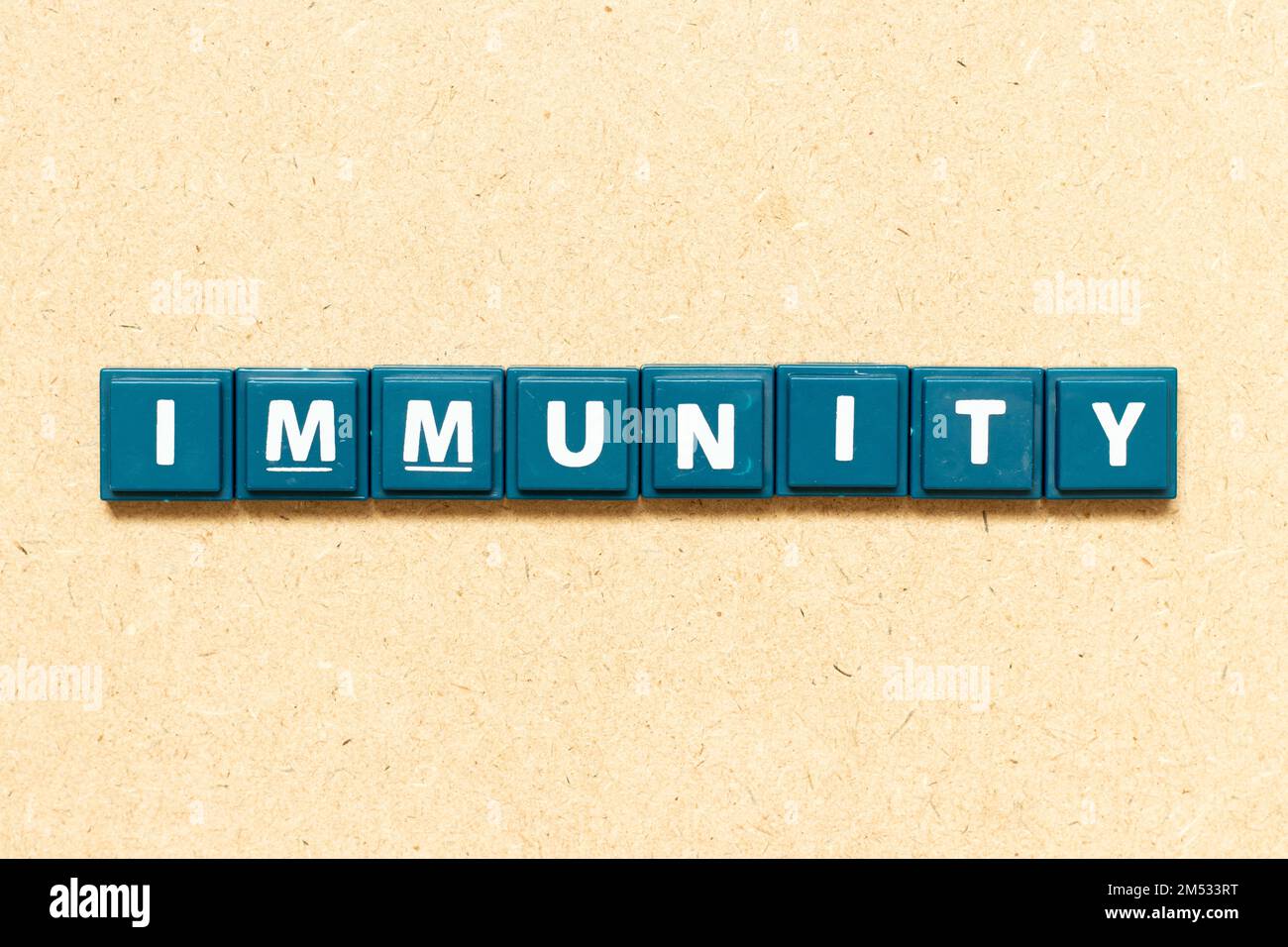 Tile alphabet letter in word immunity on wood background Stock Photo ...