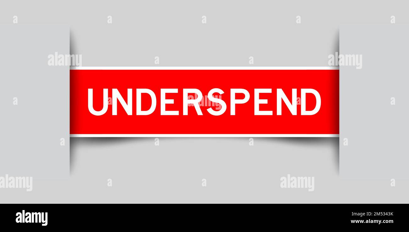 Inserted red color label sticker with word underspend on gray ...