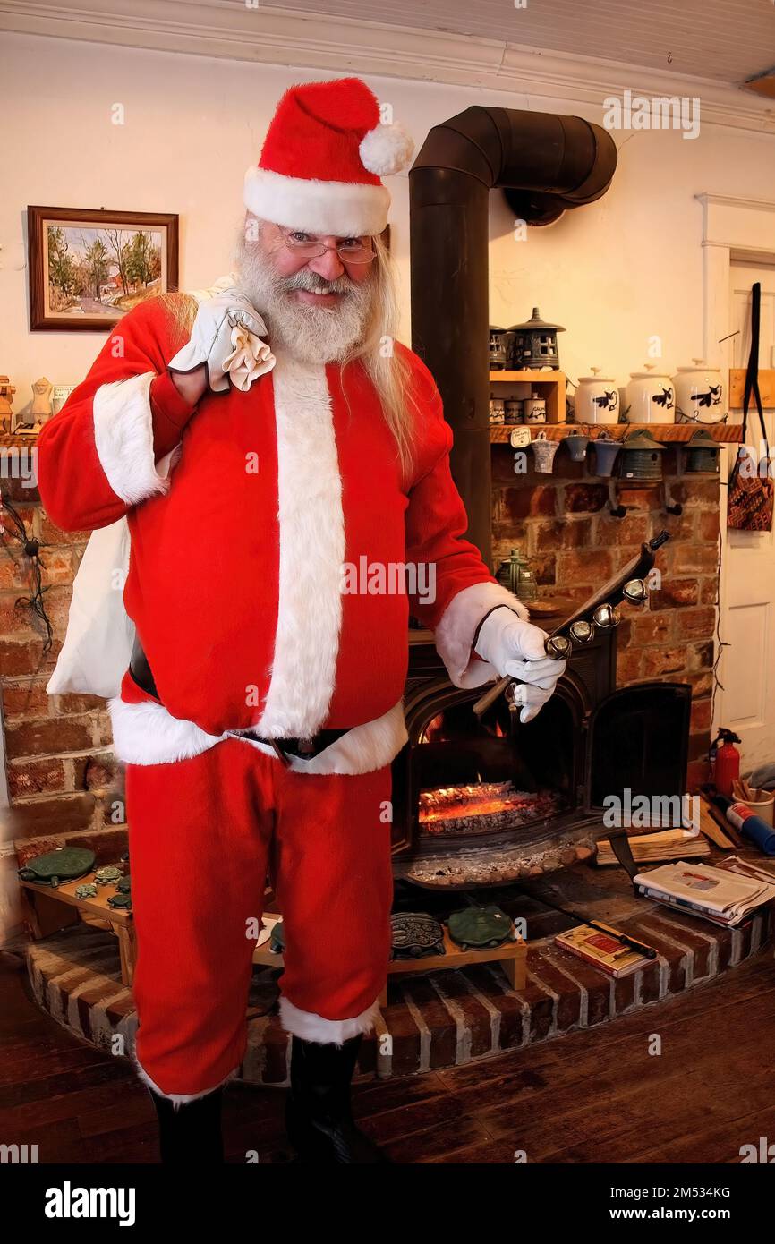 Santa in one of the stores in town with his bag over his shoulder in ...
