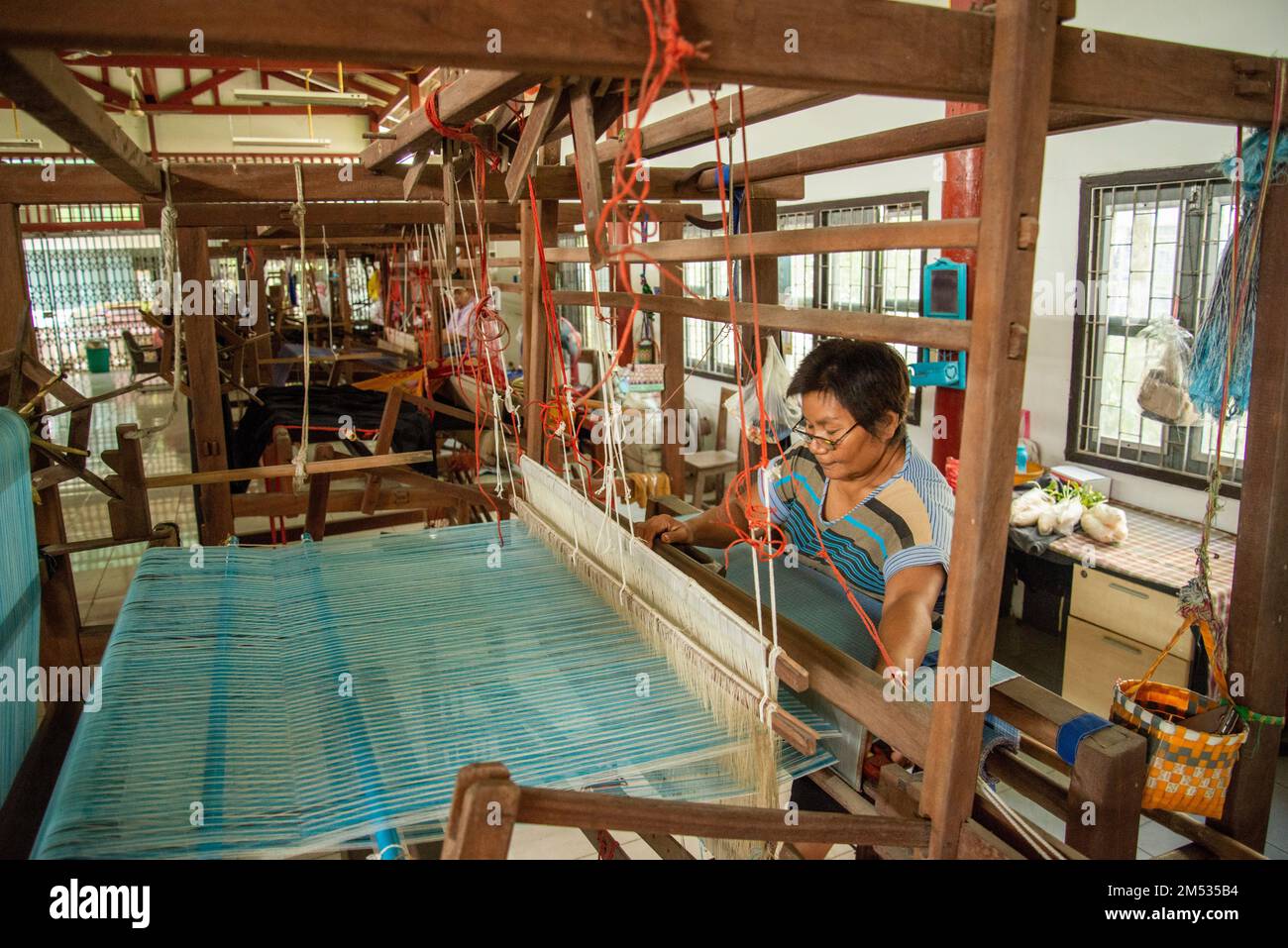 Women work at a weaving Production at the Wat Muang Mon Study centre in ...