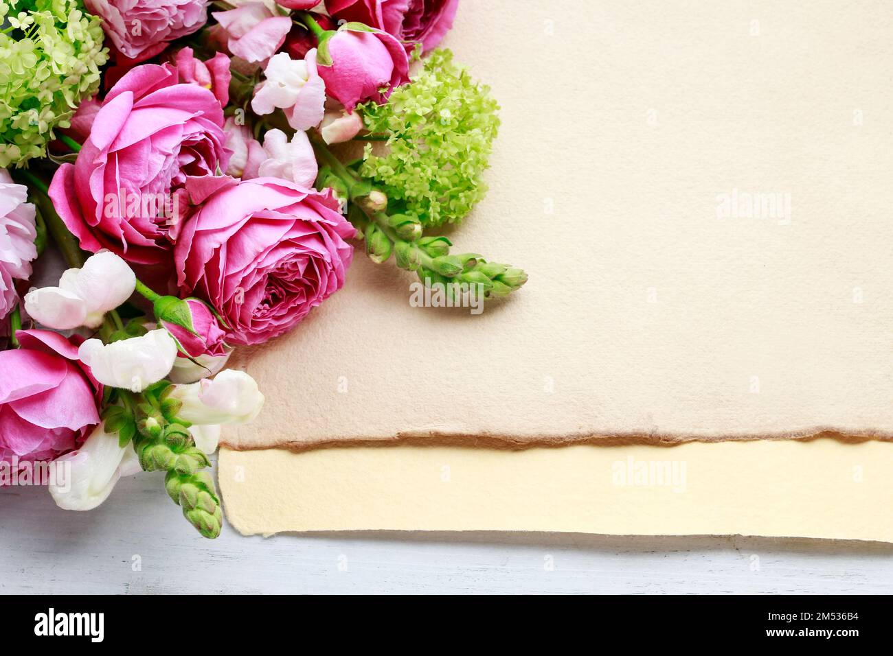Vintage sheets of paper and bouquet of flowers, copy space. Blank space ...