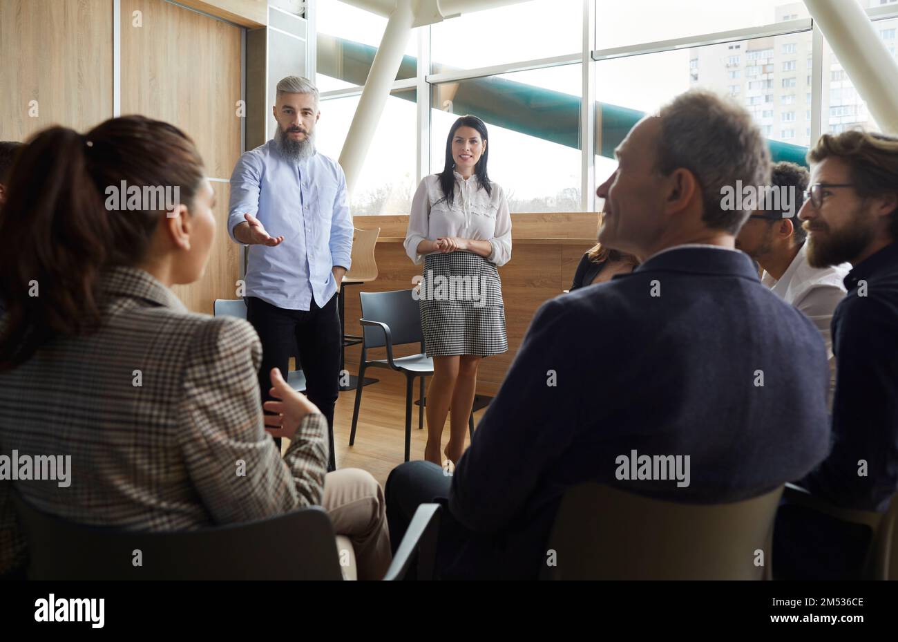 Colleagues old man and young woman making presentation in office for ...