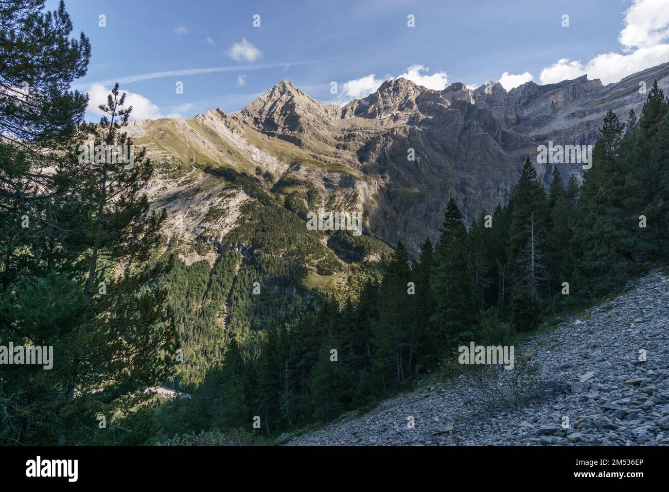 Cirque de Gavarnie with massive high rock wall formation and forest in ...