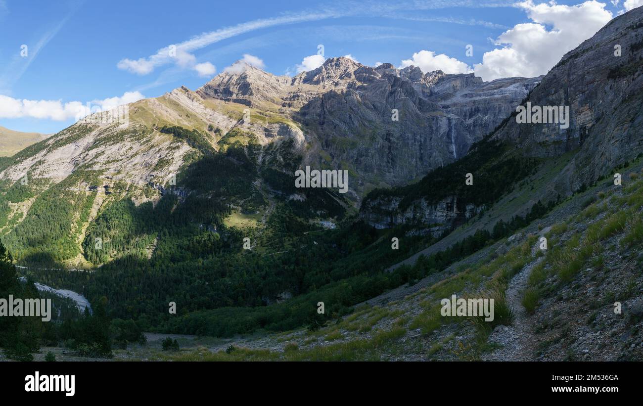 Panorama of Cirque de Gavarnie with waterfall at massive high rock wall ...
