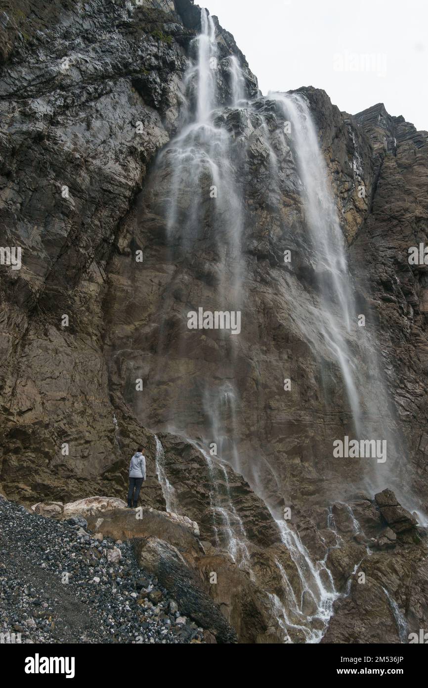 Cirque de Gavarnie with big waterfall and small person at massive high ...