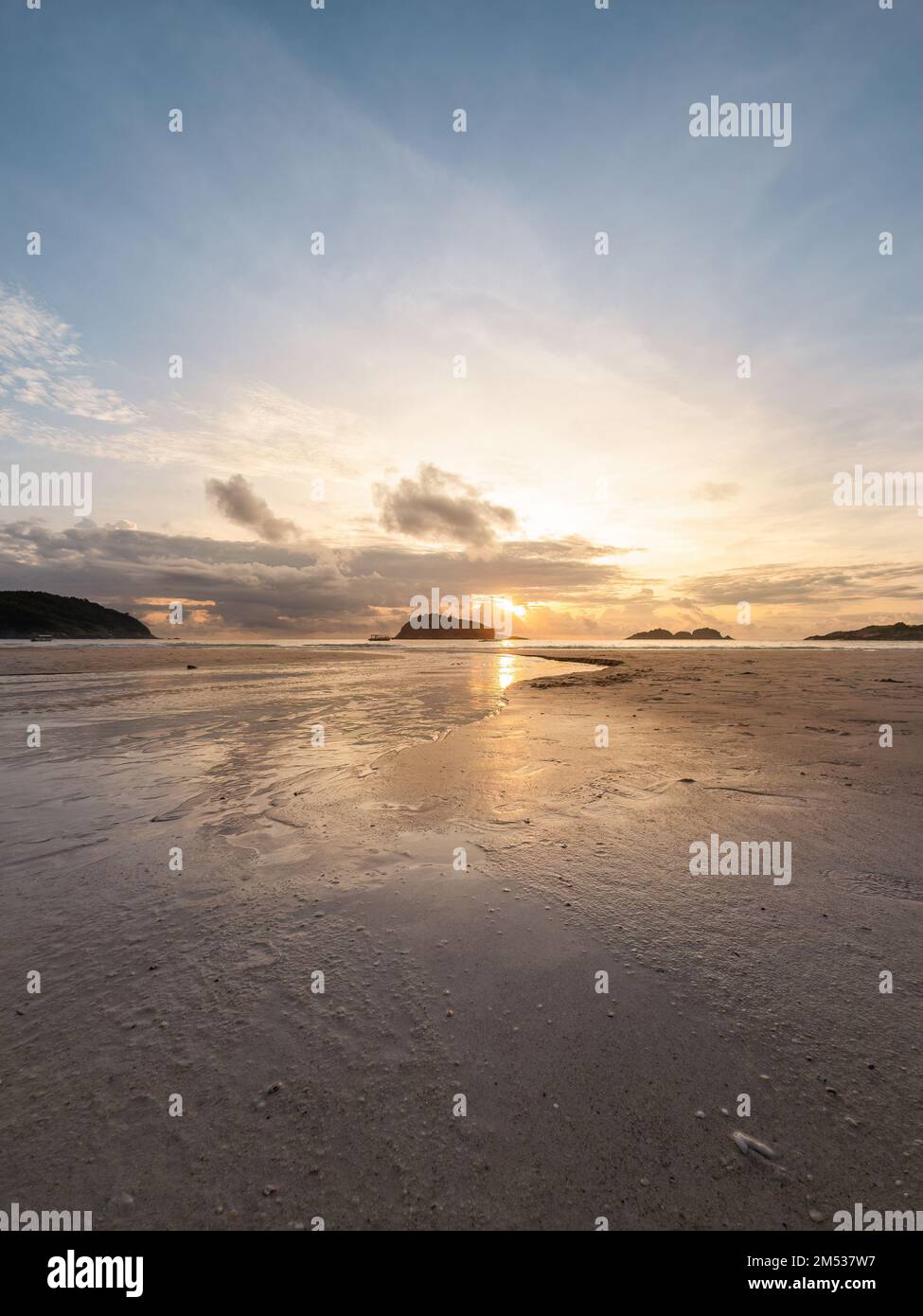 Sunrise reflections on the beach sand. Textured and watery sandy beach ...