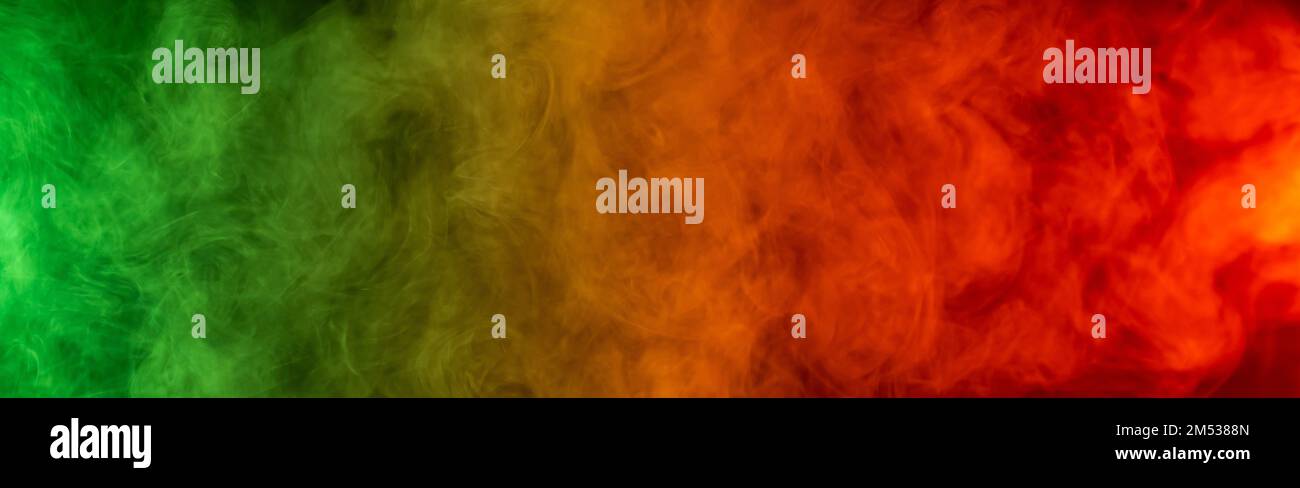 Red yellow green smoke on a black background Stock Photo - Alamy