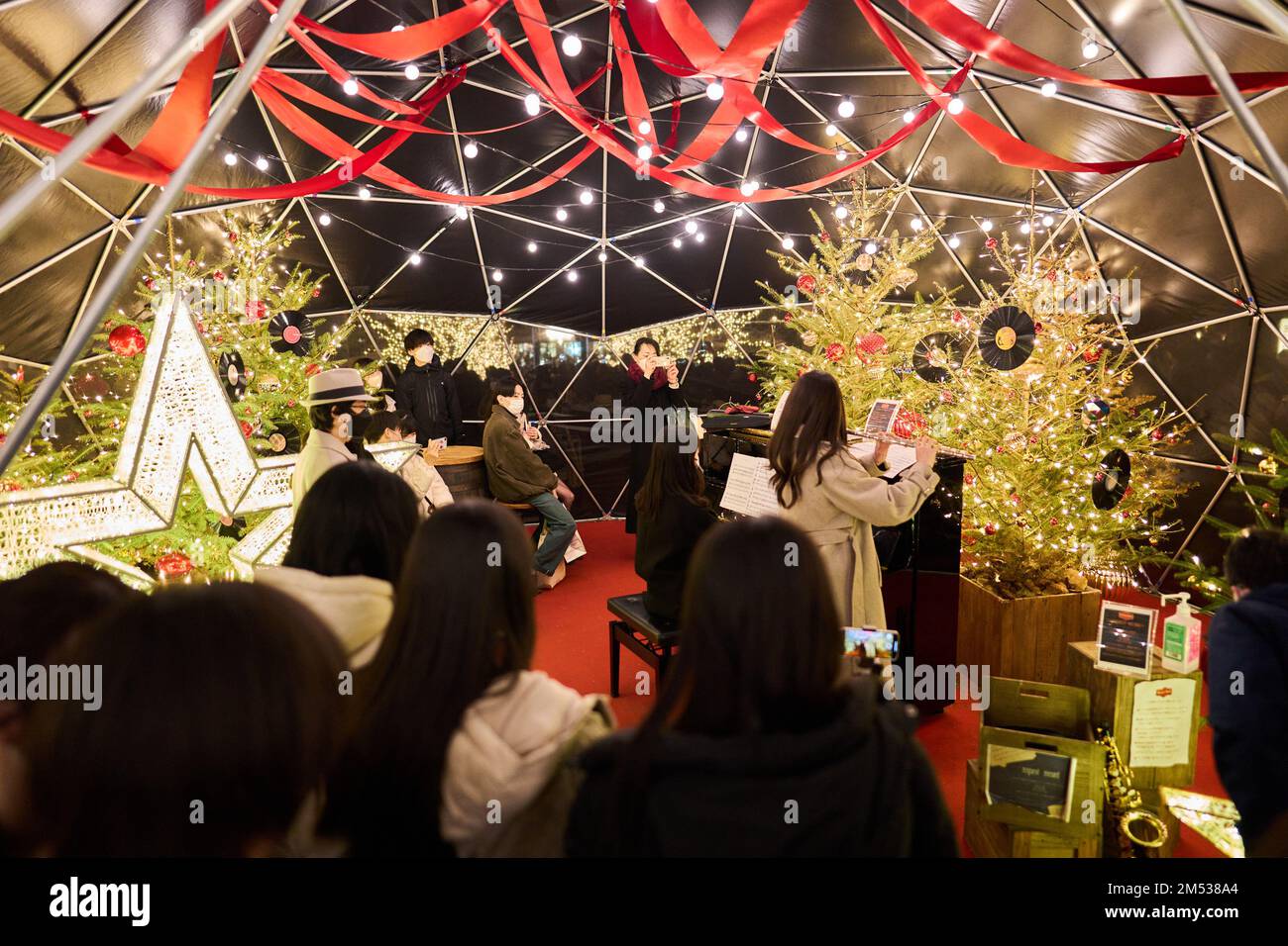 Tokyo, Japan. 25th Dec, 2022. People enjoy a music show to celebrate ...