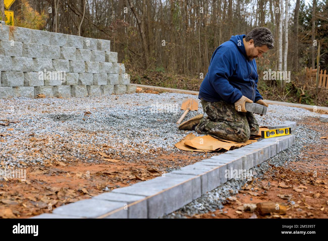 Construction worker installing concrete pavers stones for road sidewalk ... Construction worker installing concrete pavers stones for road sidewalk ...