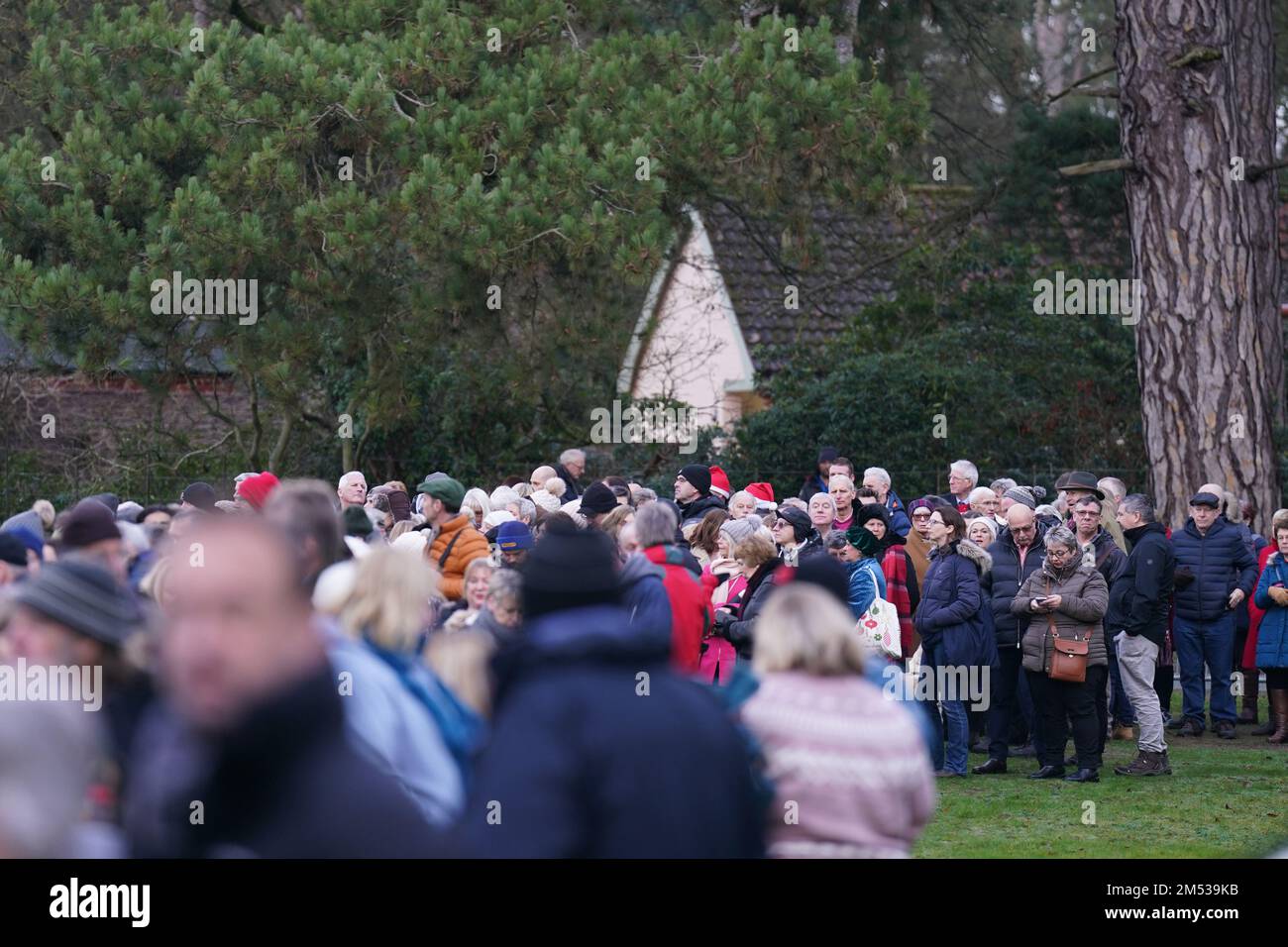 Crowds queue to see members of the royal family attending the Christmas ...