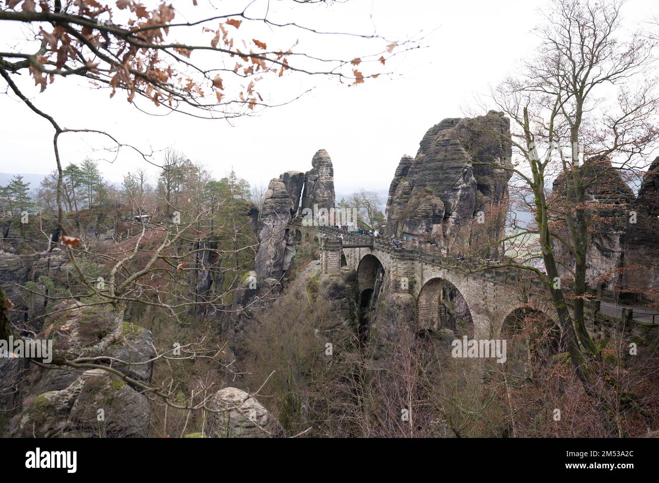 Lohmen, Germany. 25th Dec, 2022. Passers-by walk across the Bastei ...