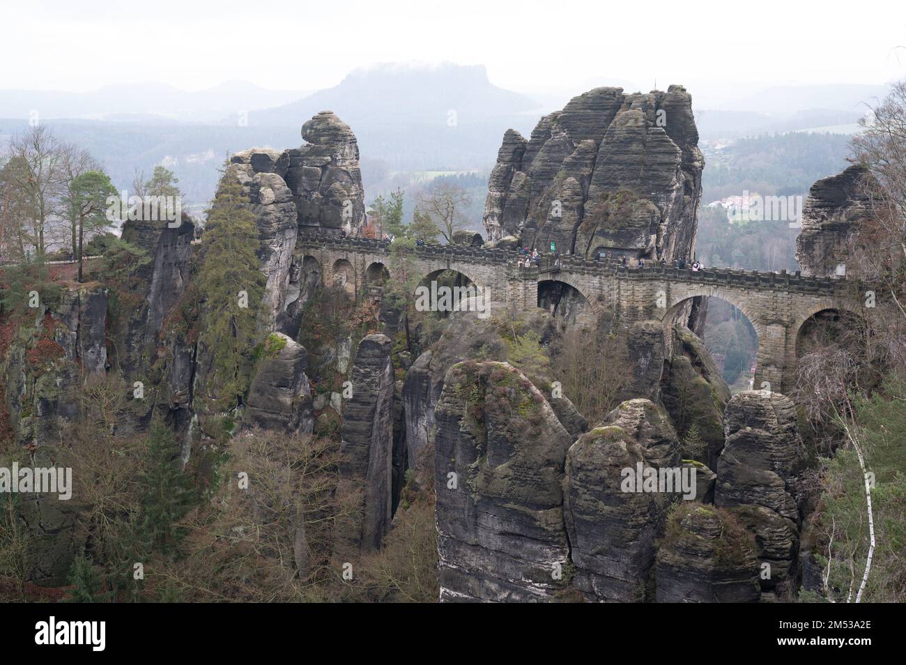 Lohmen, Germany. 25th Dec, 2022. Passers-by walk across the Bastei ...