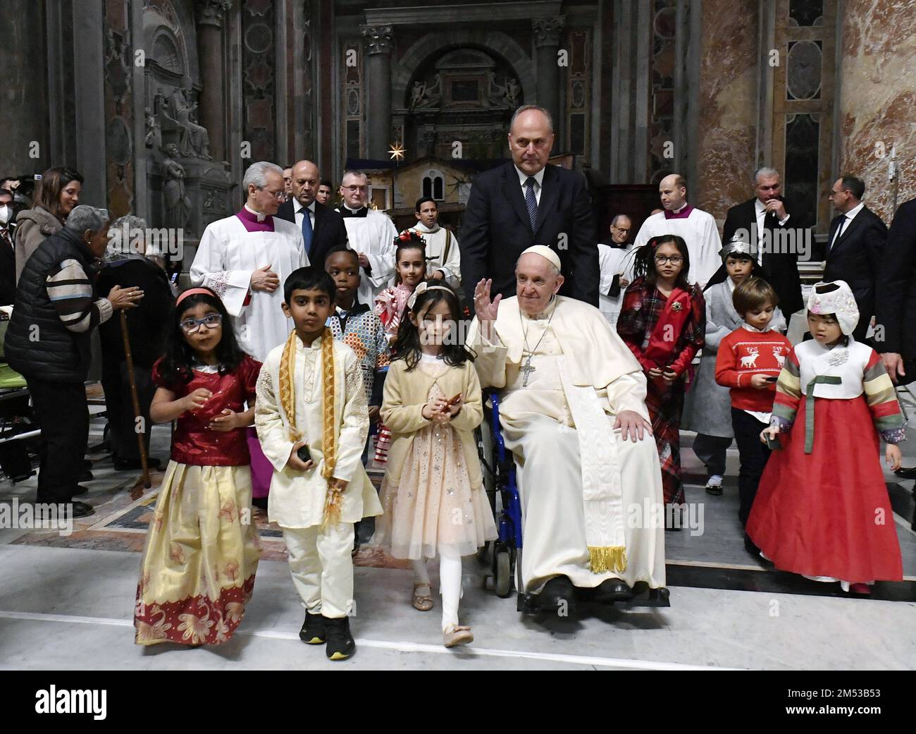 Pope Francis, in a wheel chair, celebrates the Christmas Eve mass at St ...