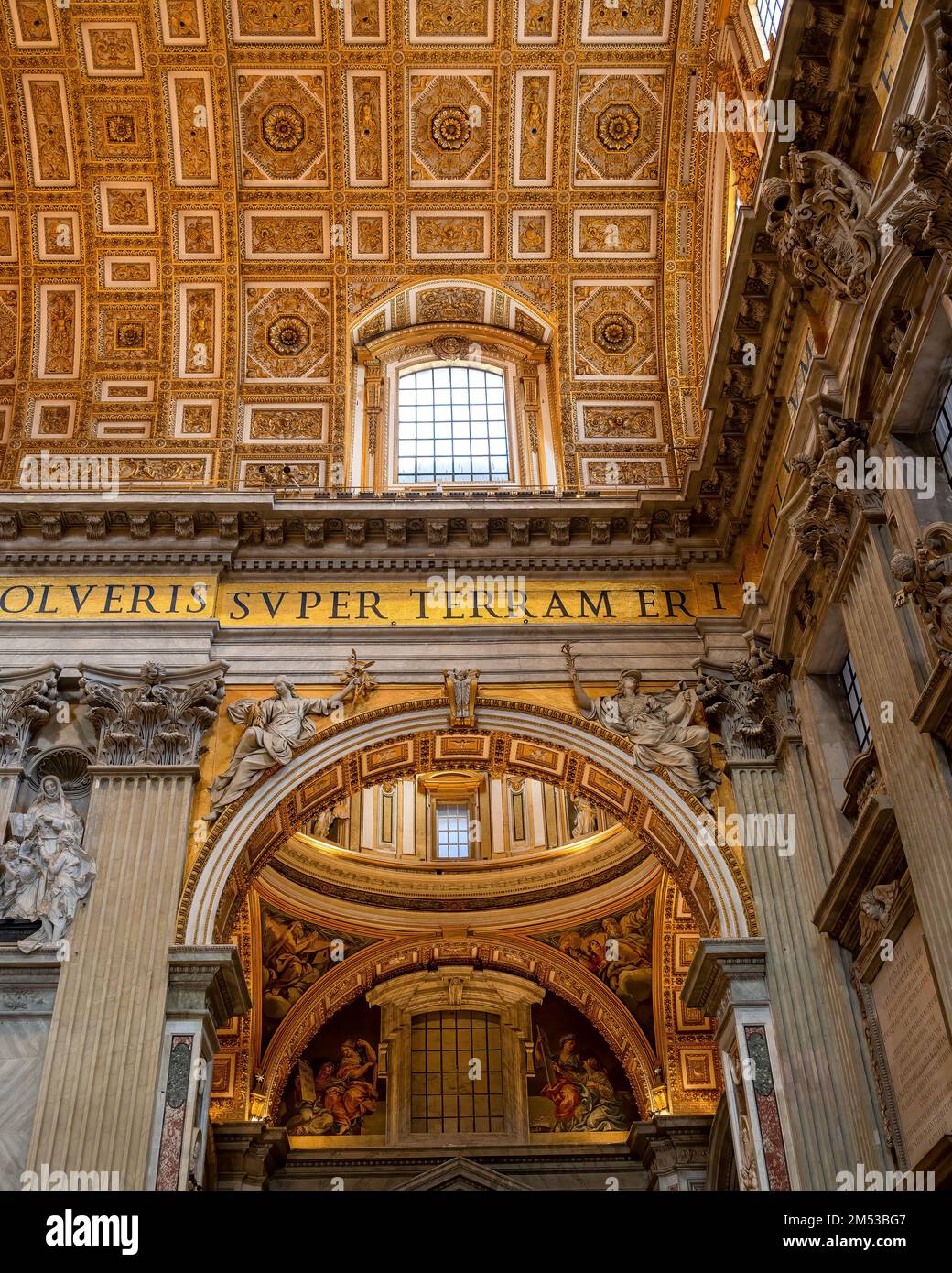 A vertical shot of the interior of Saint Peter's Basilica with a window ...