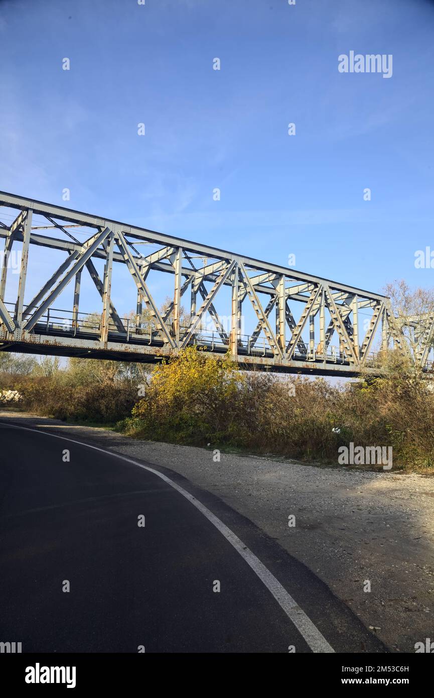 Bend in a country road under a railroad bridge Stock Photo - Alamy