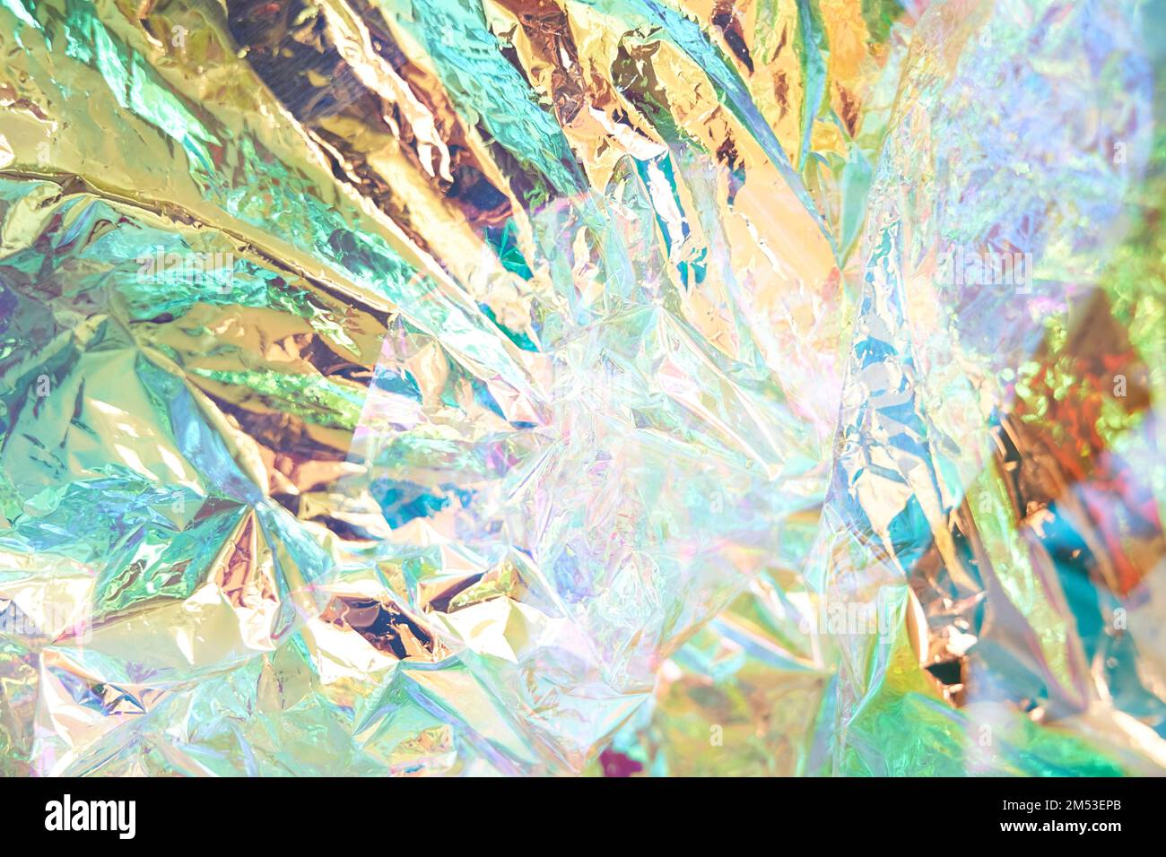 Unfocused holographic colors of mother-of-pearl foil. Crumpled ...