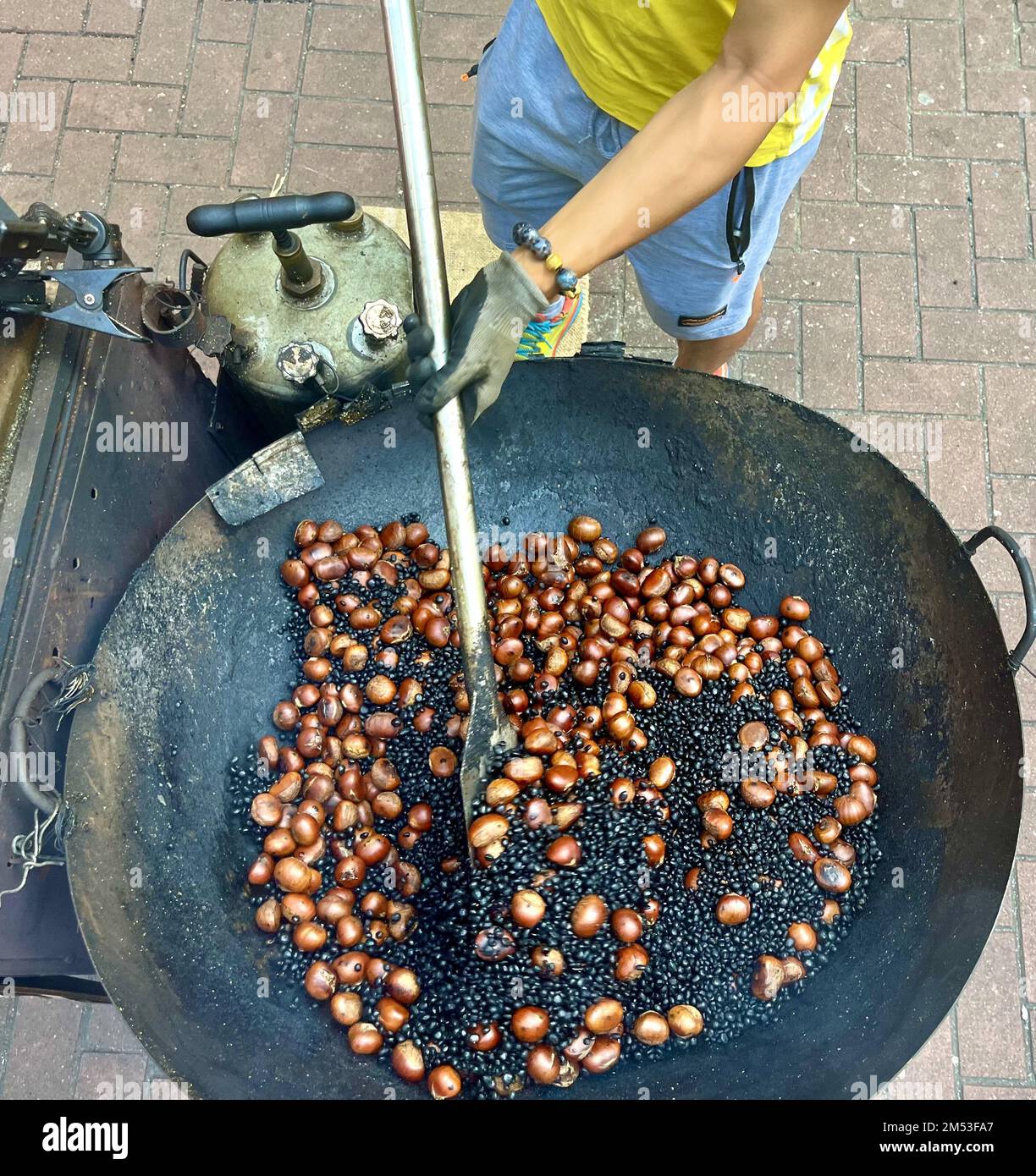Chestnuts being roasted, by Kobus Tsang (yellow) and his mother Tsang ...
