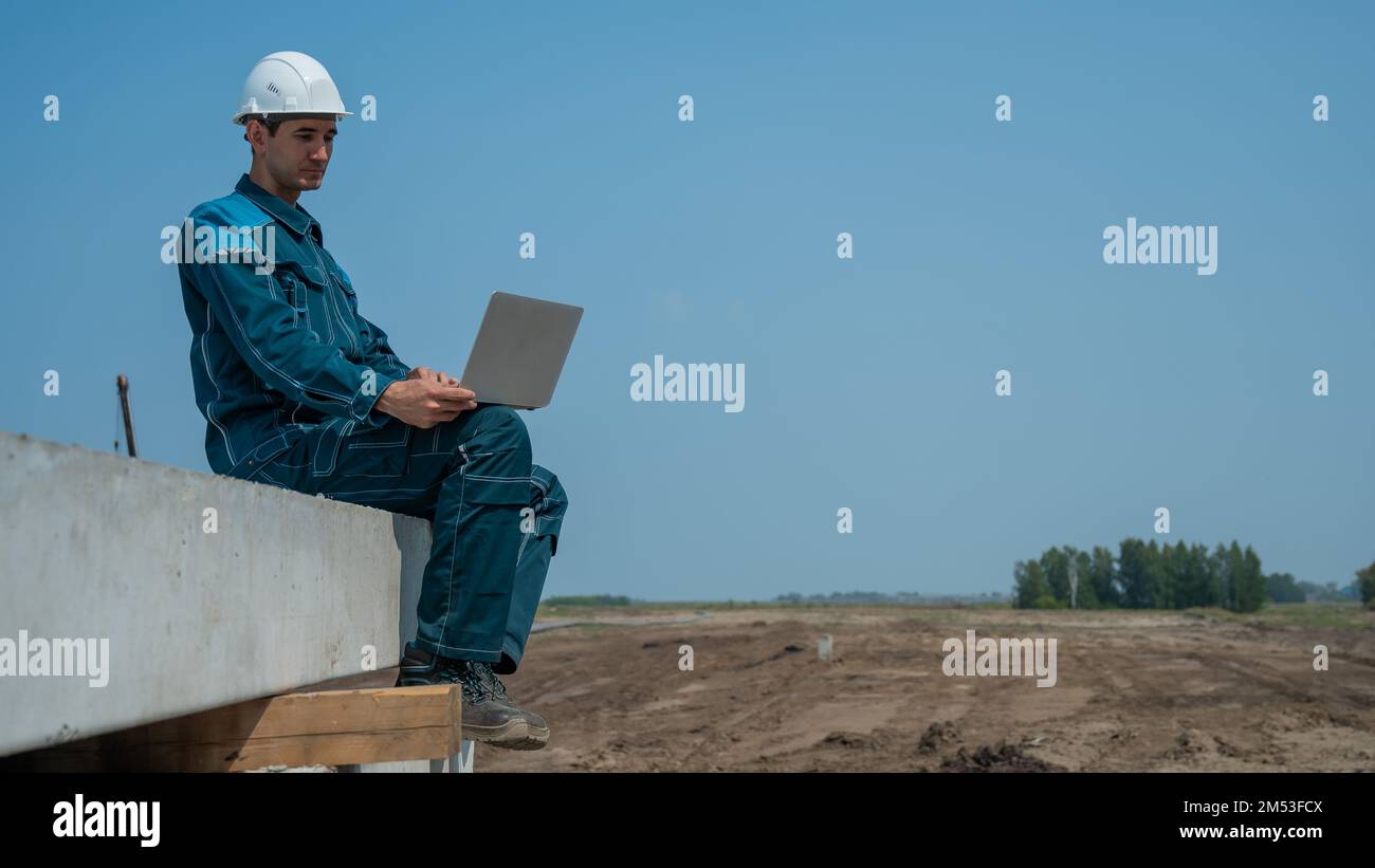 Construction engineer sits on concrete hi-res stock photography and ...