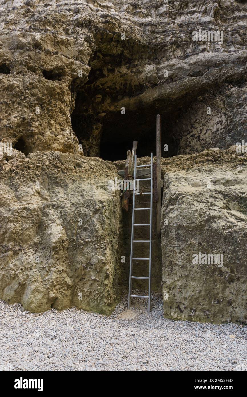 Ladder to a tunnel at the rock formation Falaise d'Amont on the beach ...