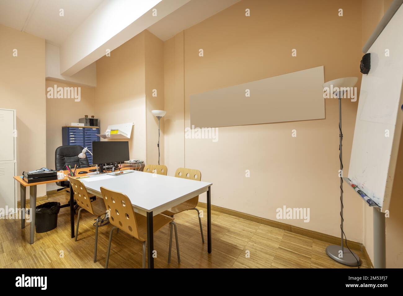 Work tables in an office with a blackboard of deleble markers Stock ...