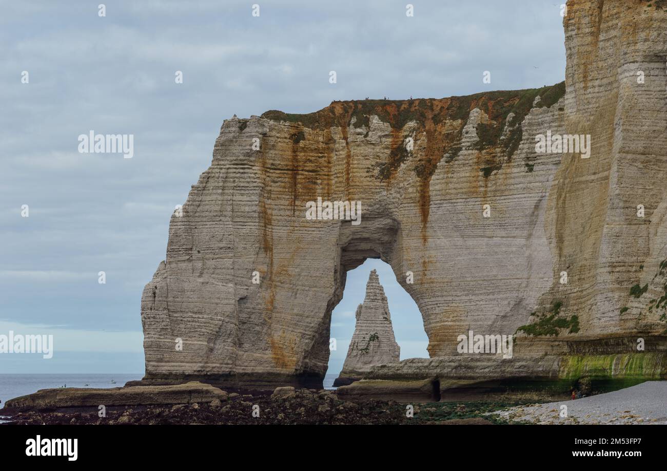 The Needle seen through the arch of the Manneporte cliff at the ...