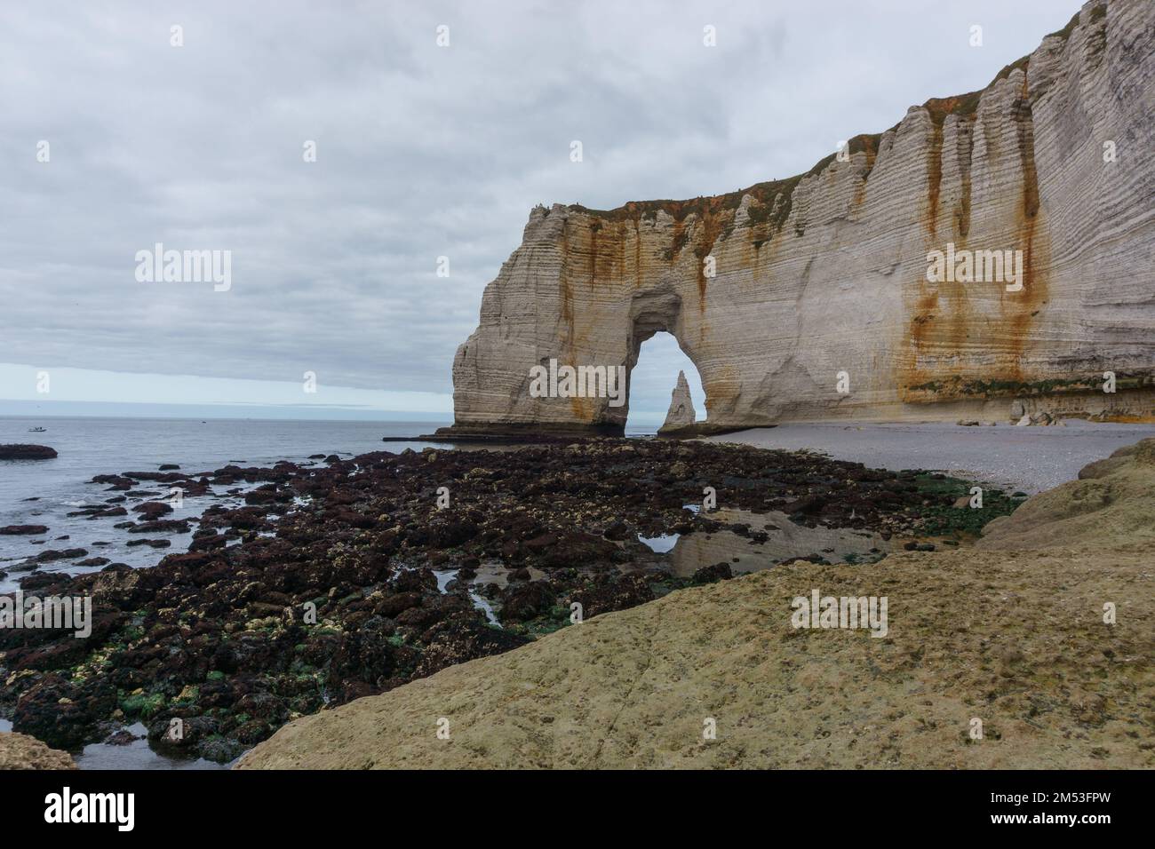 The Needle seen through the arch of the Manneporte cliff at the ...