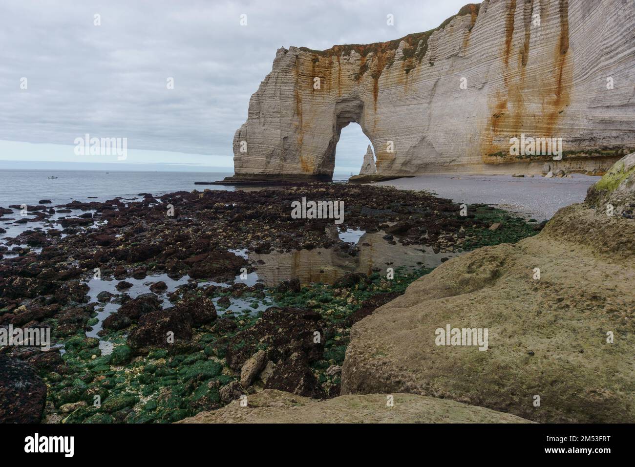 The Needle seen through the arch of the Manneporte cliff at the ...