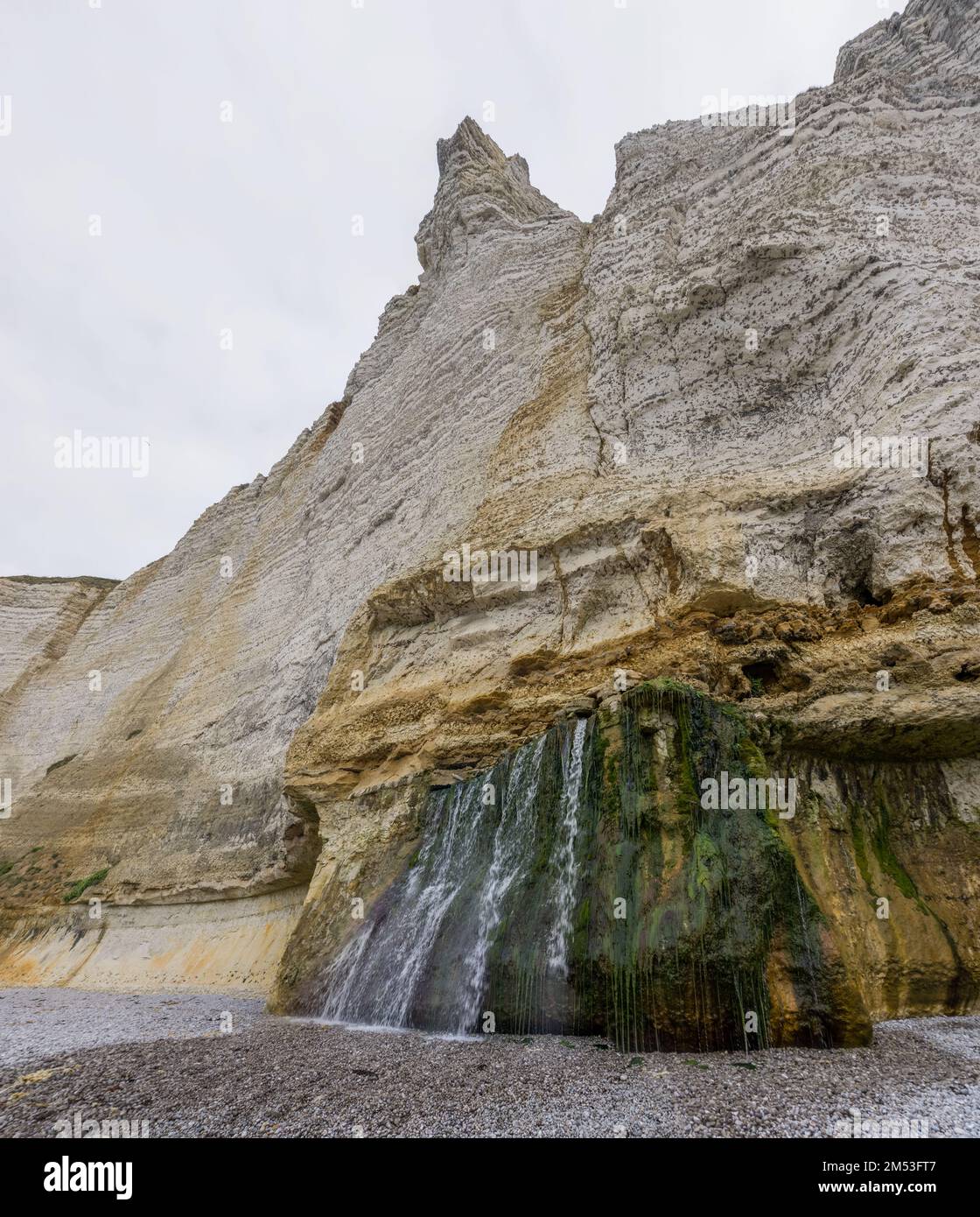 Waterfall Pisseuses of Valaine flowing out of a chalk cliff with green ...