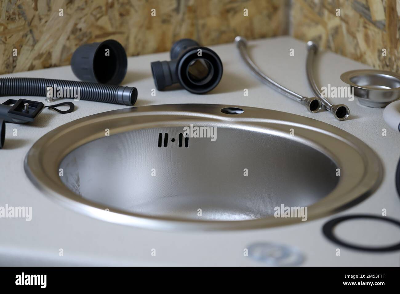 Plumbers tools and water tap ready for installation near sink on ...