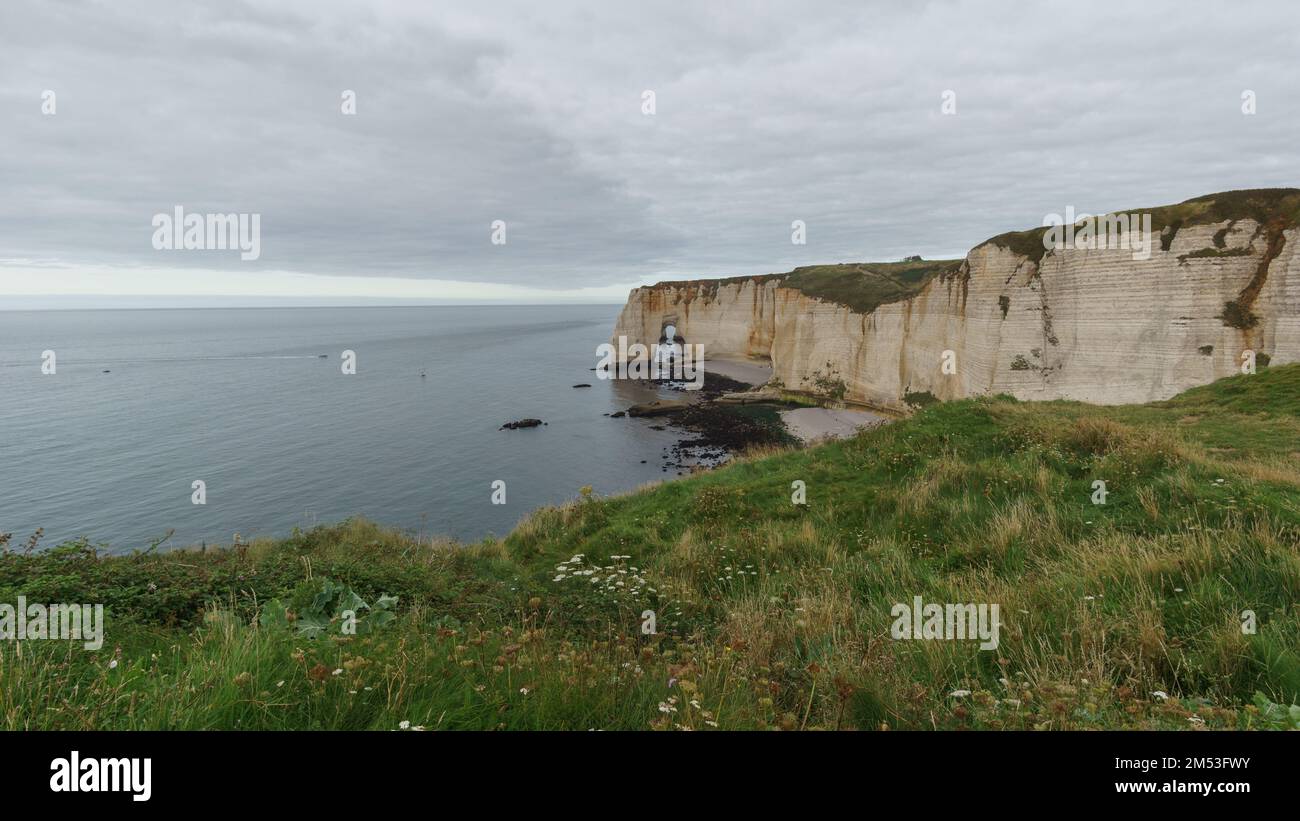 View at the Alabaster coast with arch of the Manneporte cliff and ...