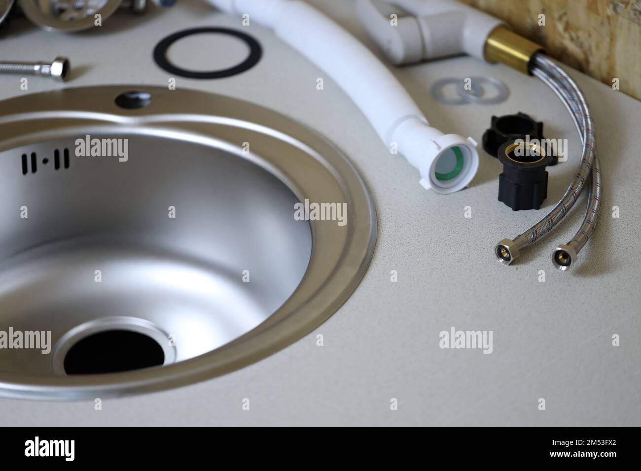 Plumbers tools and water tap ready for installation near sink on ...