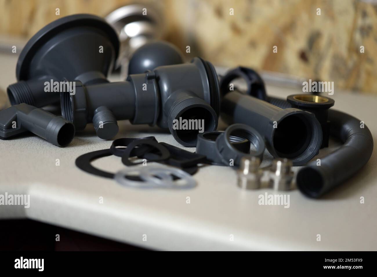 Plumbers tools and water tap ready for installation near sink on ...