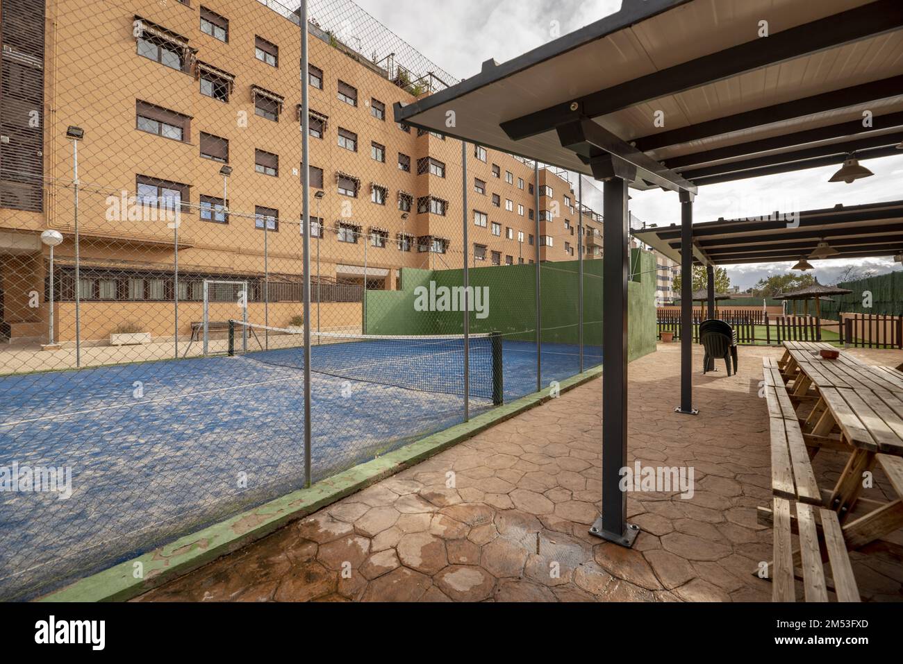 Common areas of an urbanization with a tennis court with gates and ...