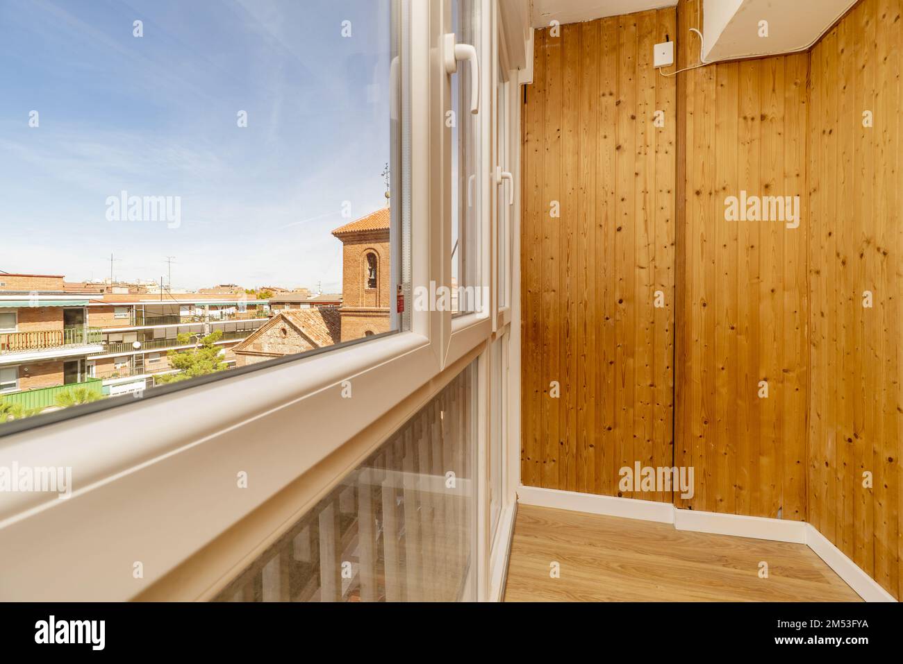 Closed terrace of a house with walls covered in wood, white aluminum ...
