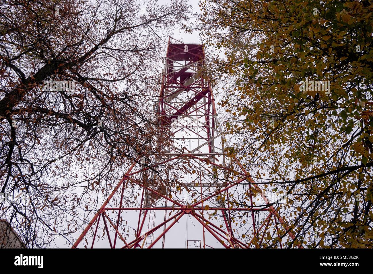 An old television and radio tower in faded colors looks vertically at ...