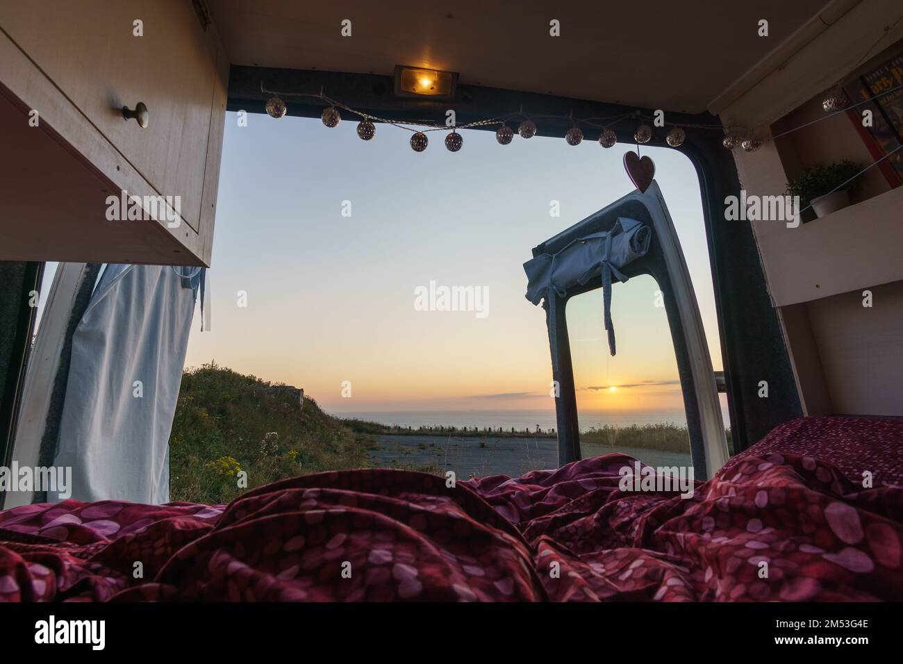 View out of a self built camper van with fairy lights on a colorful ...