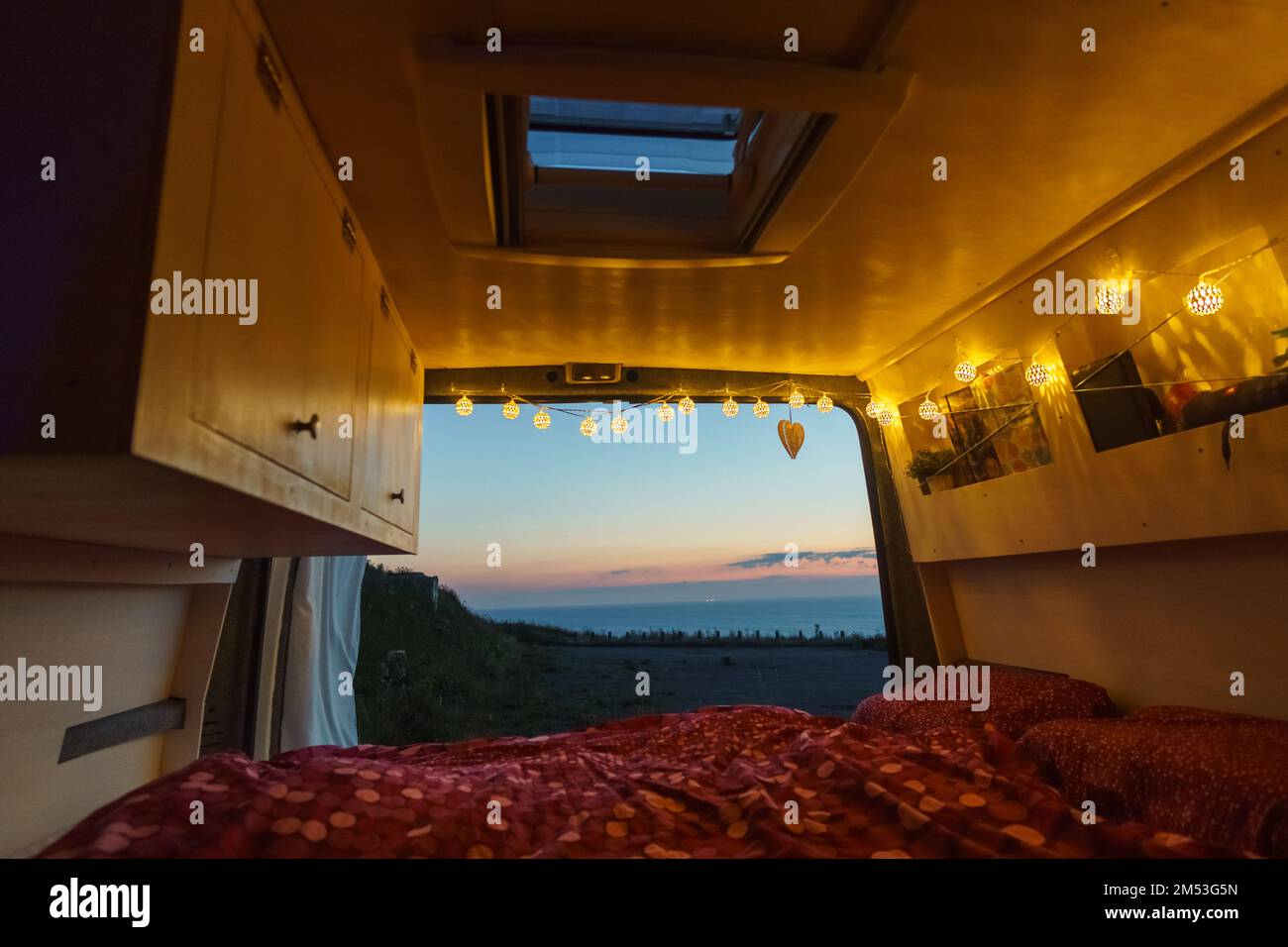 View out of a self built camper van with fairy lights on a colorful ...