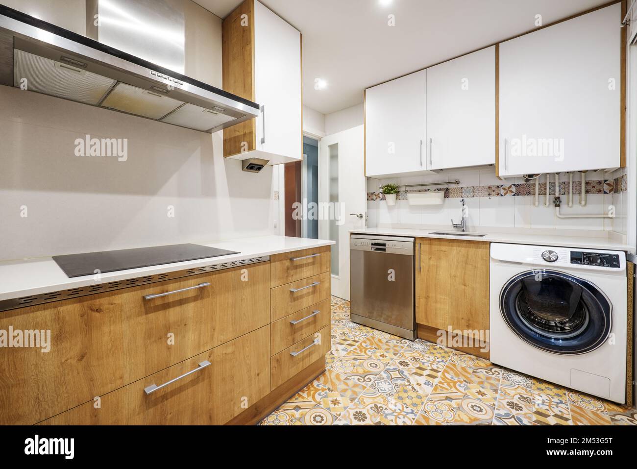 Walls of a kitchen furnished with wooden base units with large drawers ...