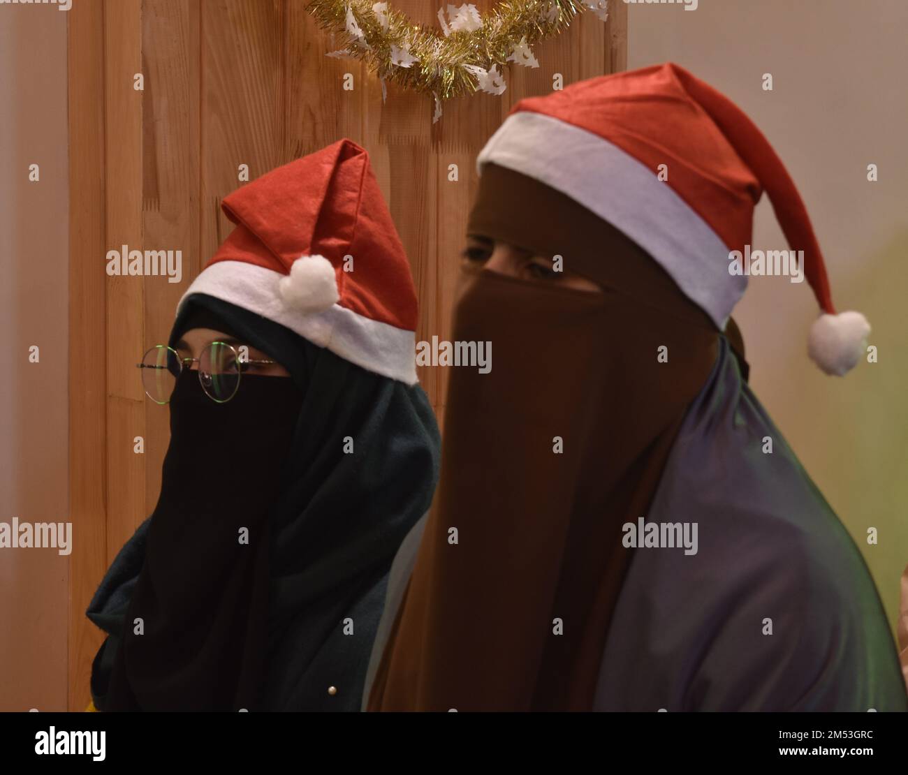 Srinagar, India. 25th Dec, 2022. Veiled Kashmiri Muslim women celebrate ...