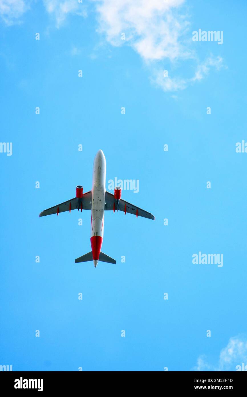 Airplane in flight. A view of the fuselage and the blue sky background ...