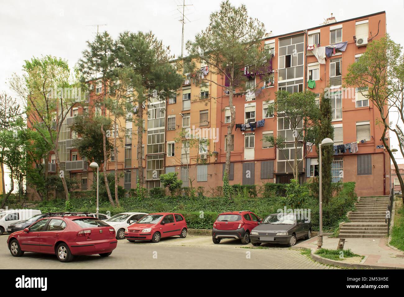 Facade of a modest residential building in a neighborhood with an area ...