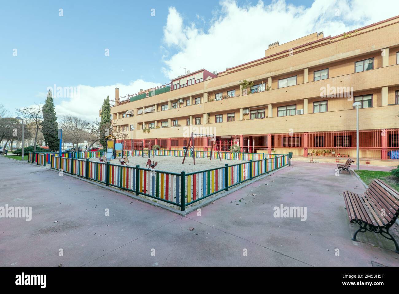 Facade of residential buildings with terraces and metal fence with ...