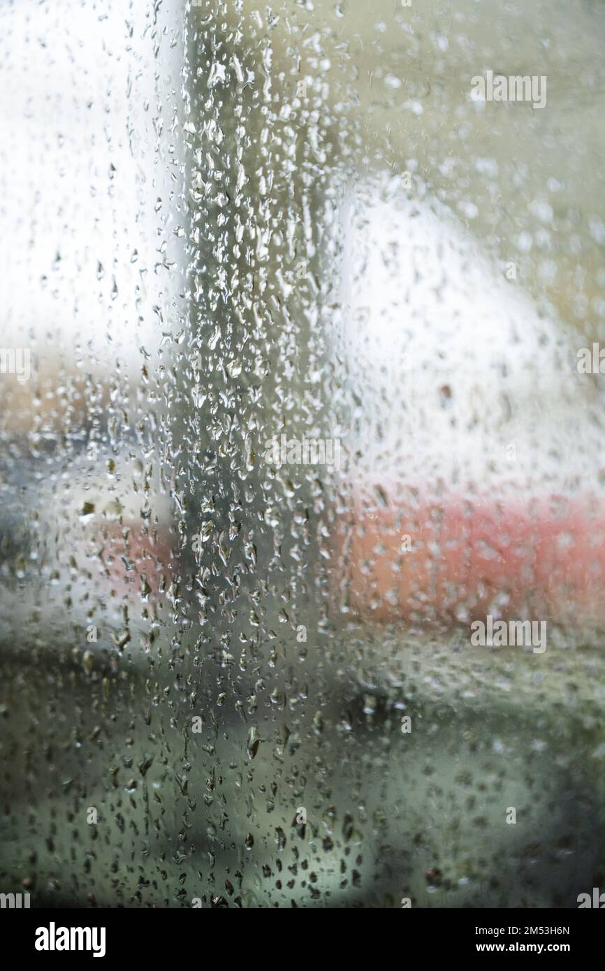 Vertical image of glass window full of raindrops on a winter day Stock ...