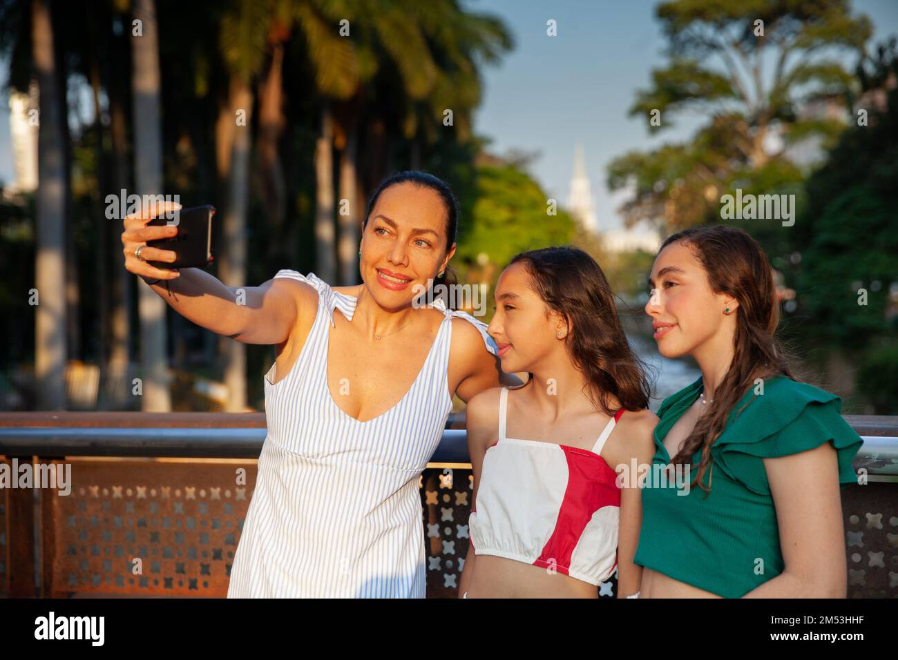 Tourists taking a selfie in one of the bridges along the Cali River ...