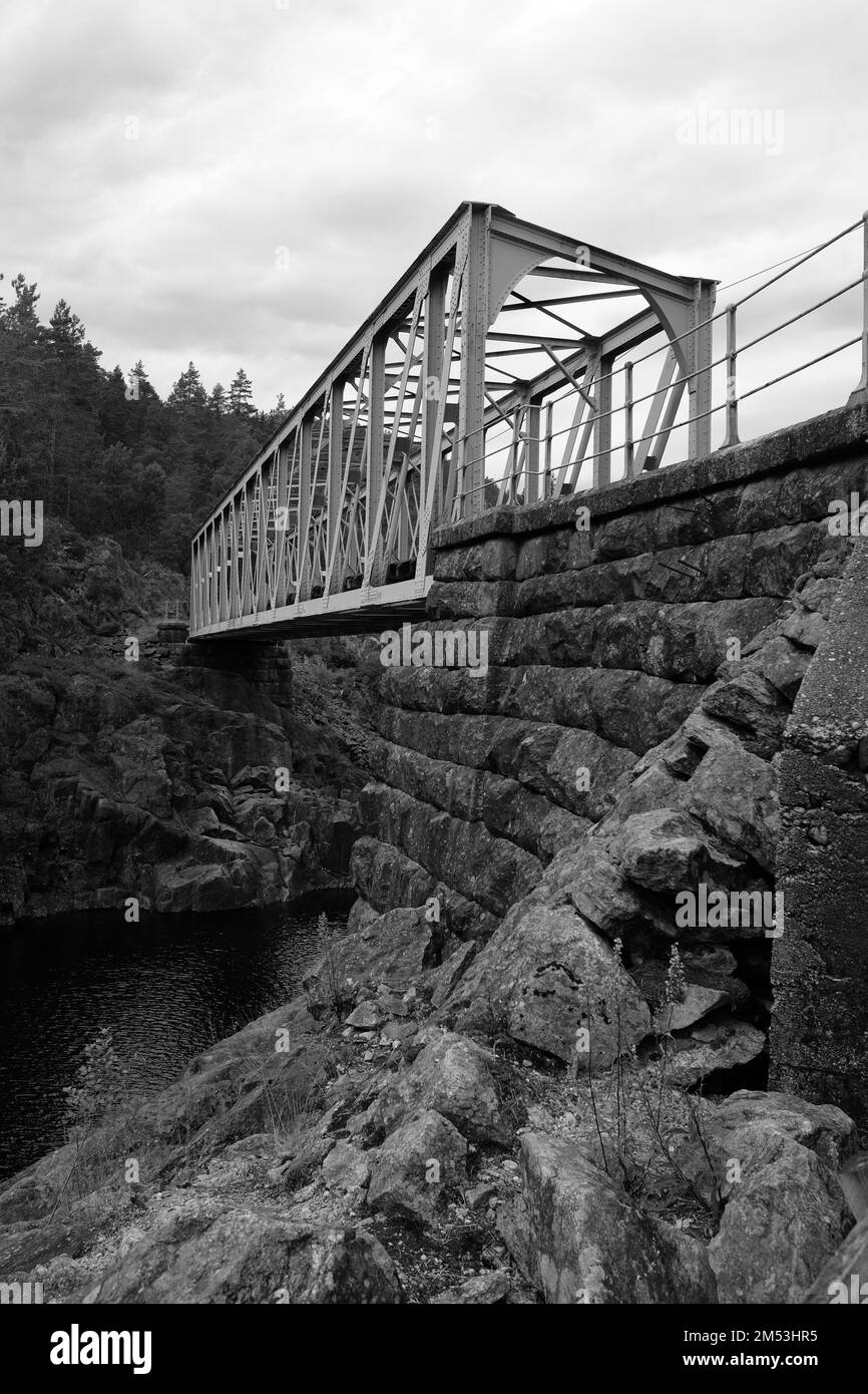 A vertical view of a bridge over the river in grayscale Stock Photo - Alamy