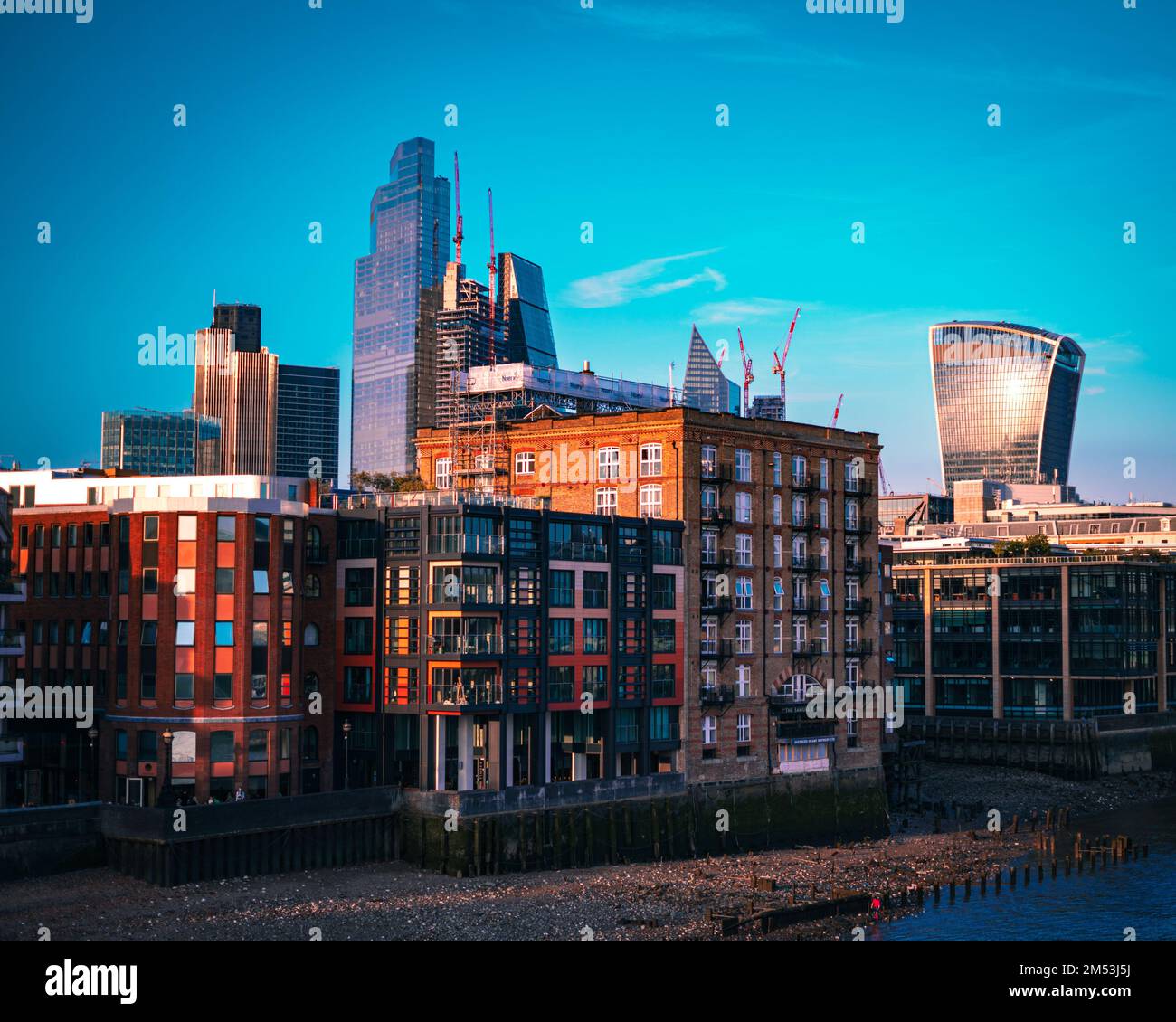 The Sir John Lyon House building by the river under sunset blue sky ...