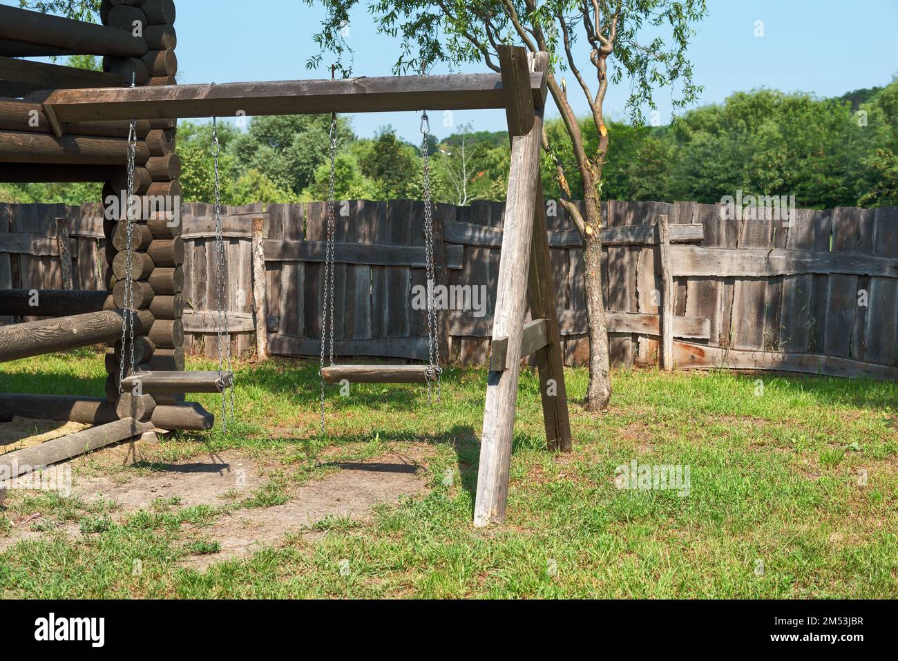 Old wooden swing, wooden playground, two swings Stock Photo - Alamy