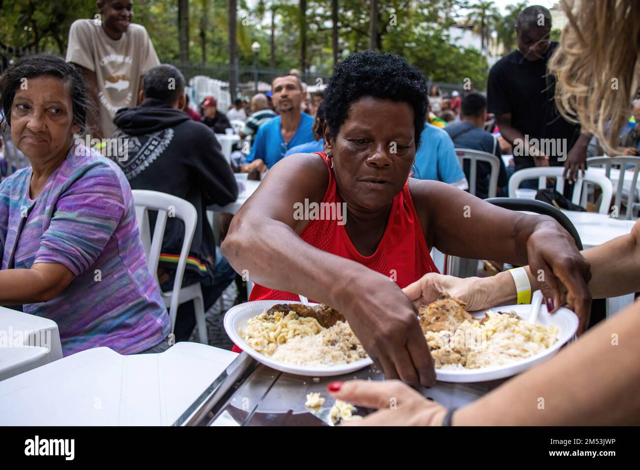 Rio De Janeiro, Brazil. 24th Dec, 2022. A homeless woman receives a ...