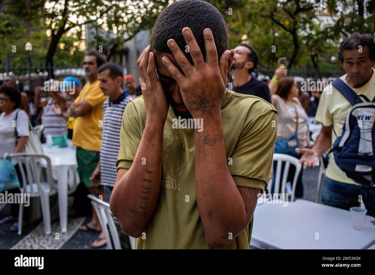 Rio De Janeiro, Brazil. 24th Dec, 2022. Homeless pray before receiving ...