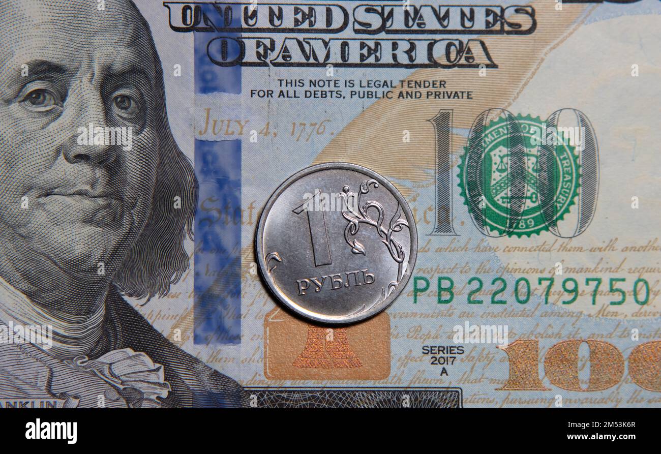 1 Russian ruble on a 100-dollar bill. The concept of the economic ...